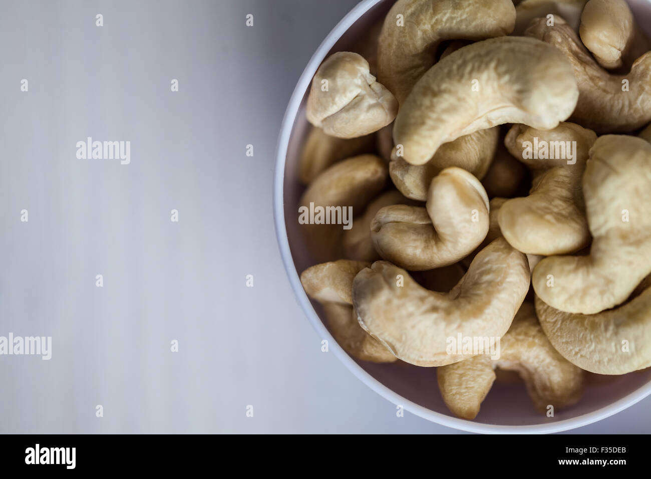 Portion cup of cashew nuts Stock Photo - Alamy