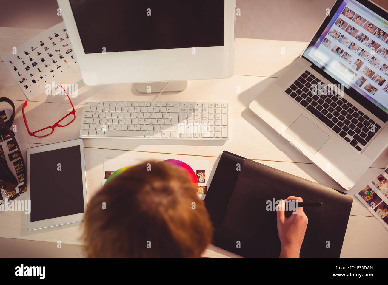 Graphic designer working at desk Stock Photo - Alamy