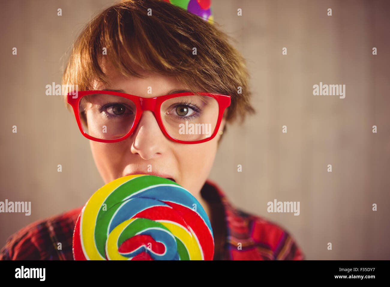 Pretty young woman eating lollipop Stock Photo - Alamy