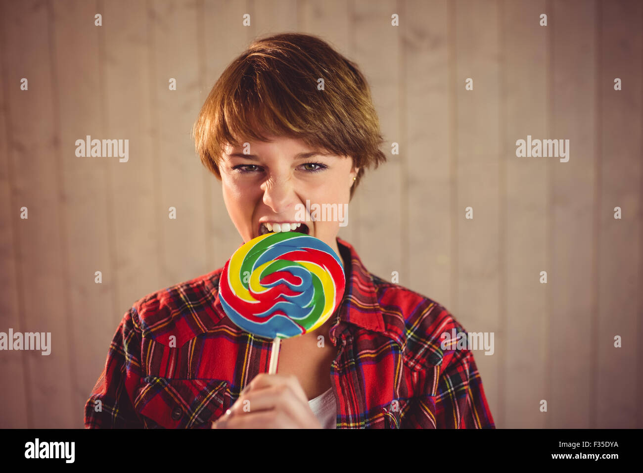 Pretty young woman eating lollipop Stock Photo - Alamy
