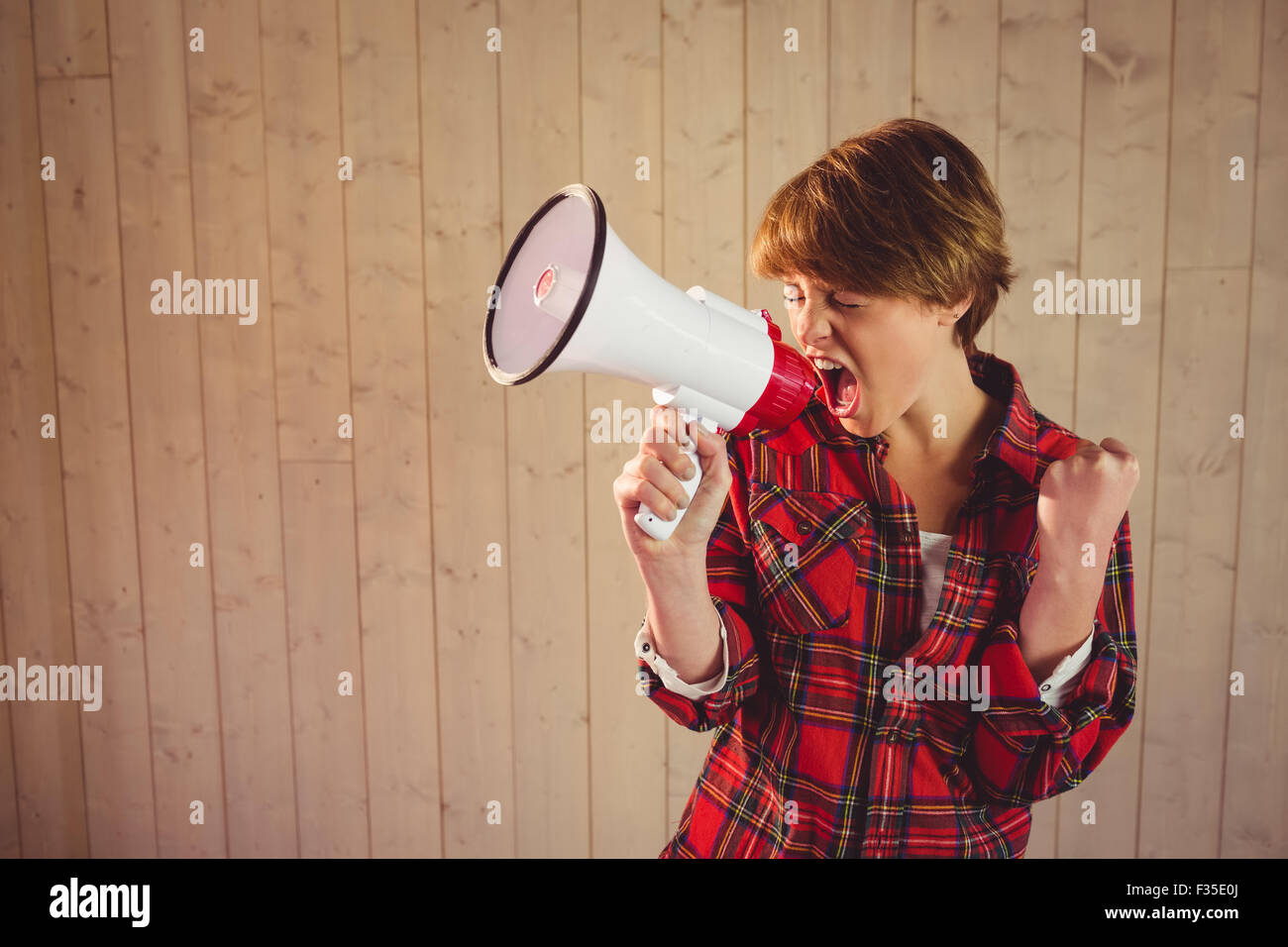 Pretty young woman using megaphone Stock Photo - Alamy