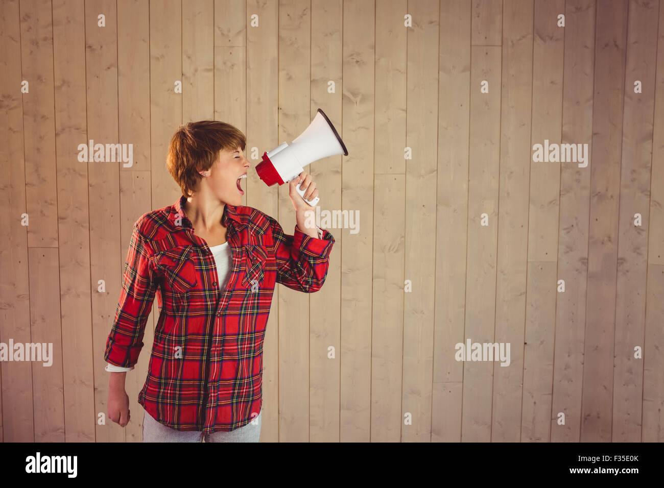 Pretty young woman using megaphone Stock Photo - Alamy