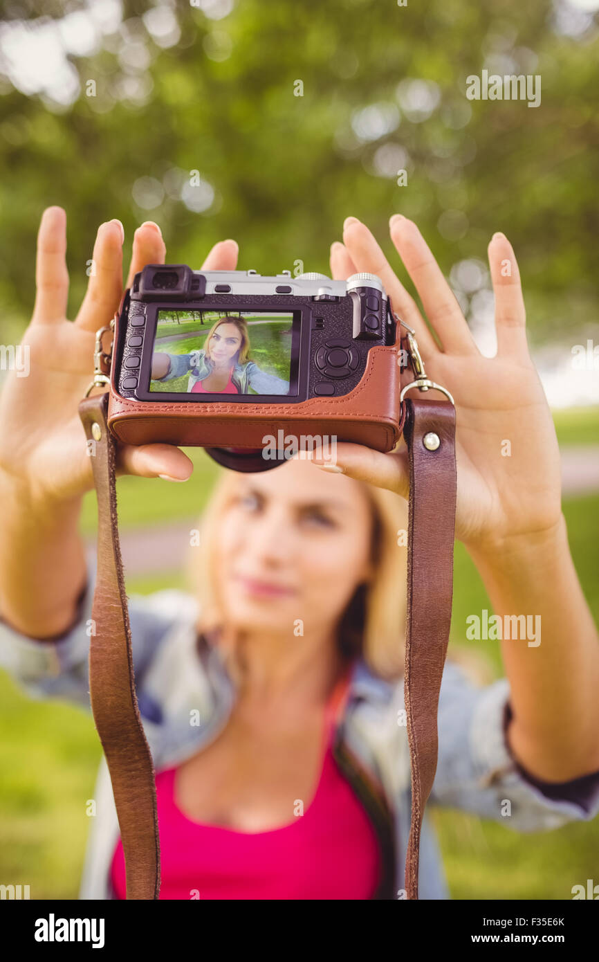 Woman taking self portrait with camera Stock Photo - Alamy