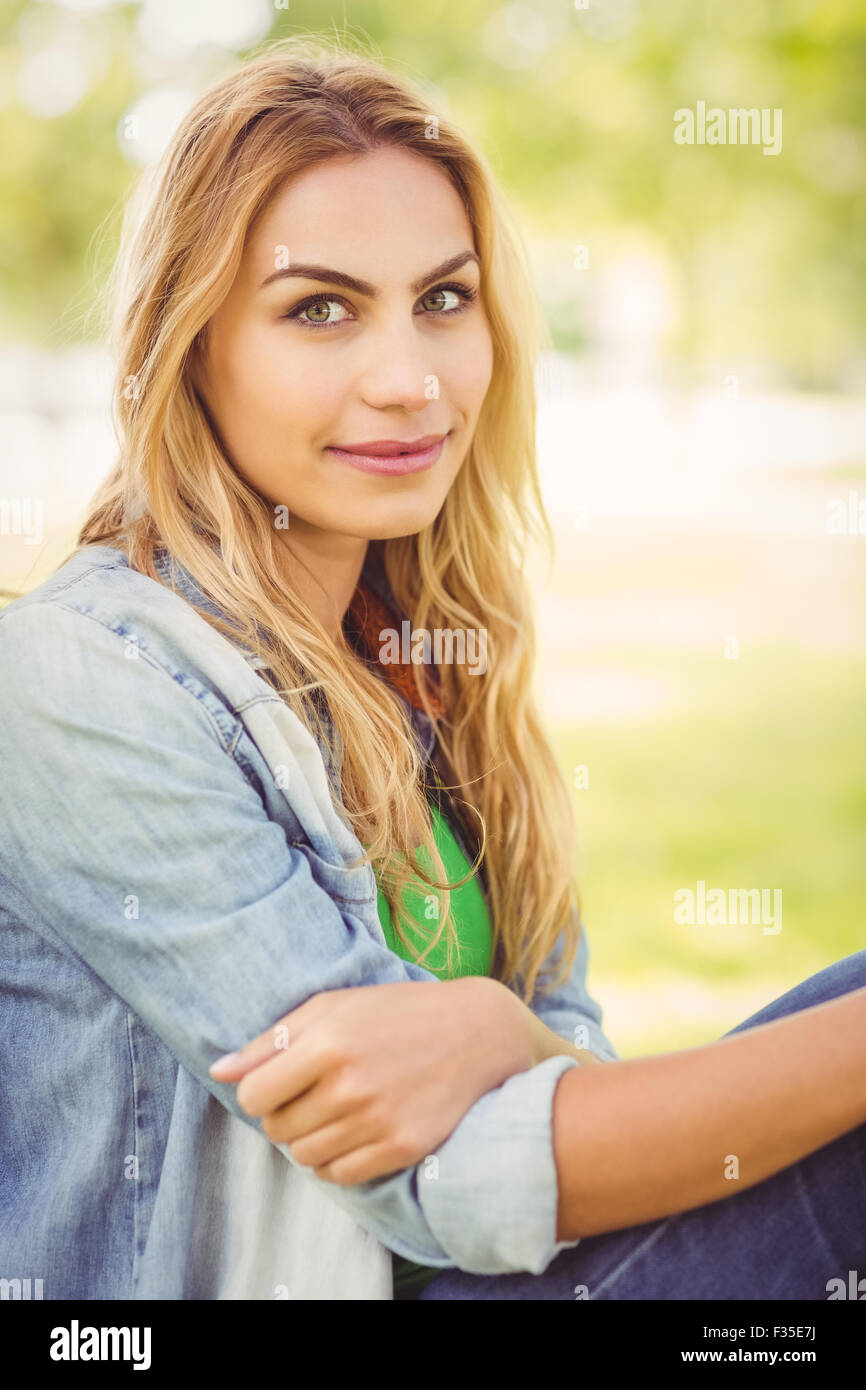 Portrait of smiling woman sitting Stock Photo - Alamy