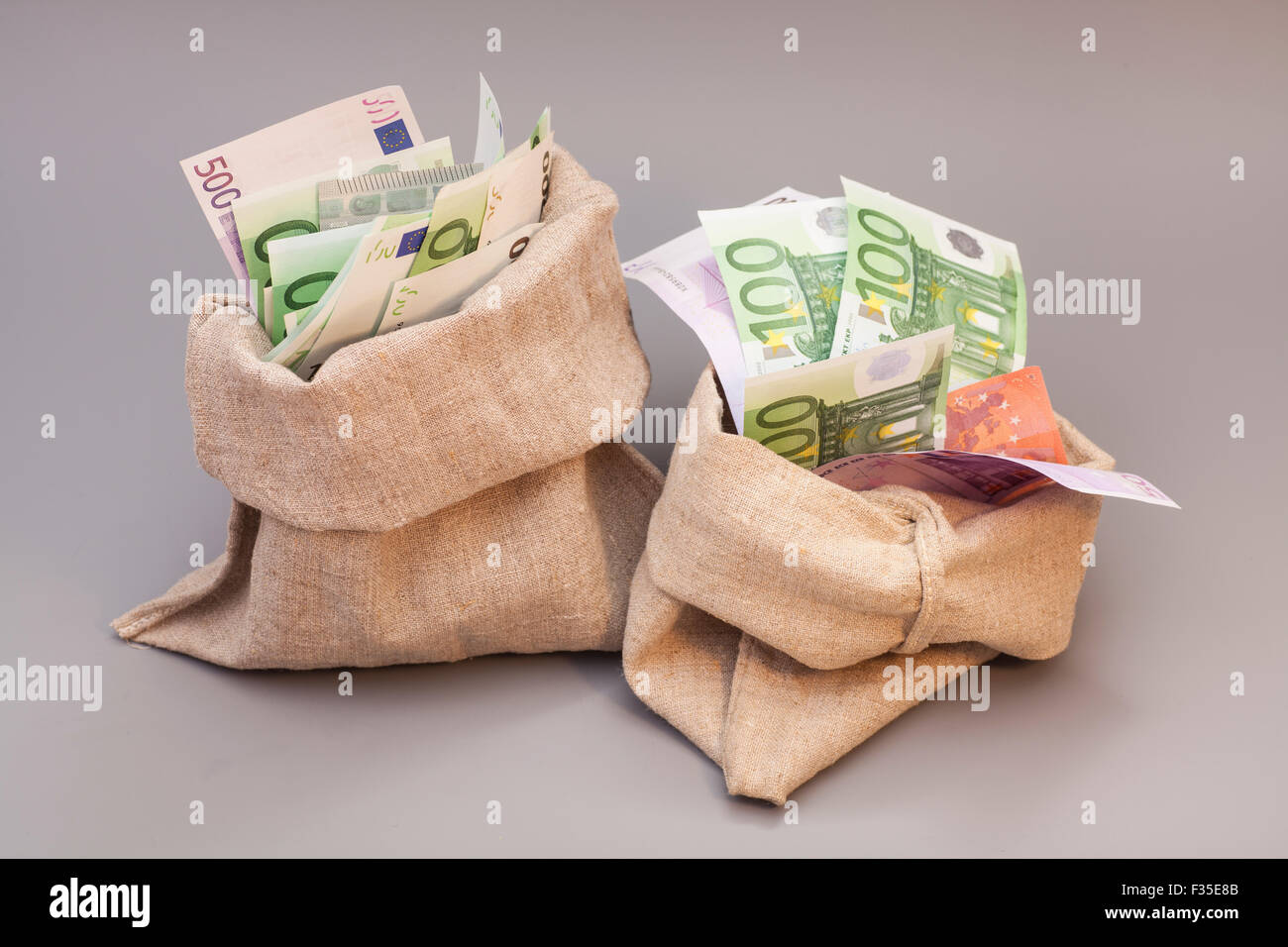 Two Money bags with euro isolated on gray background Stock Photo - Alamy
