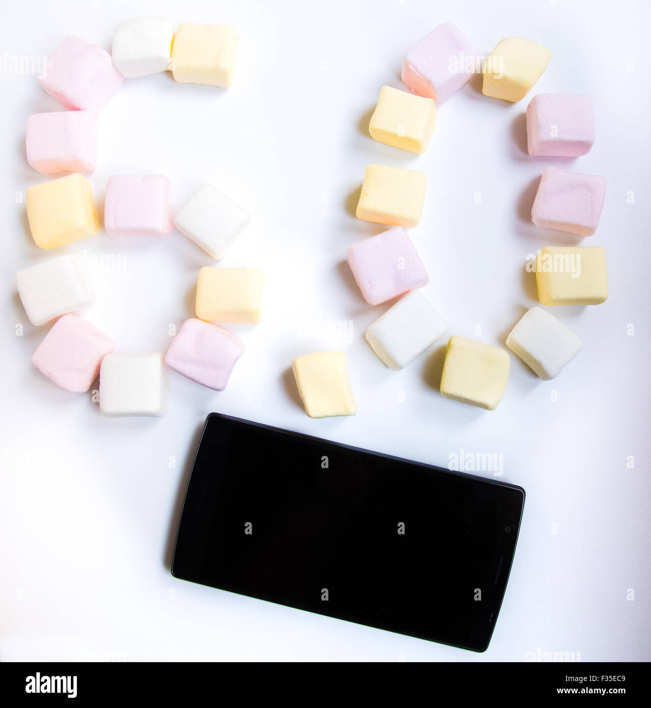 Mobile phone with colored marshmallows candies Stock Photo - Alamy
