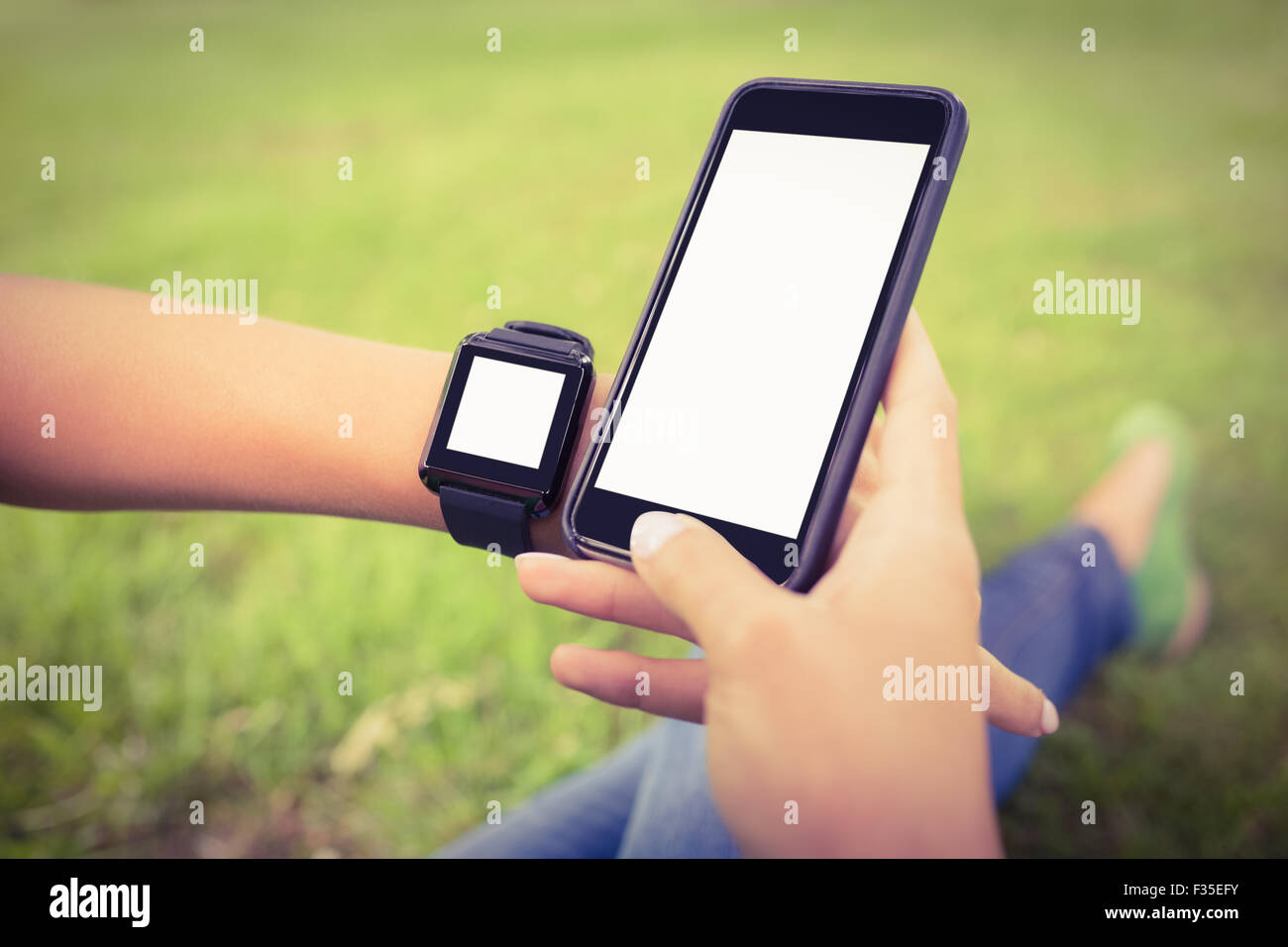 Cropped hands of person wearing smart watch and holding smartphone at ...