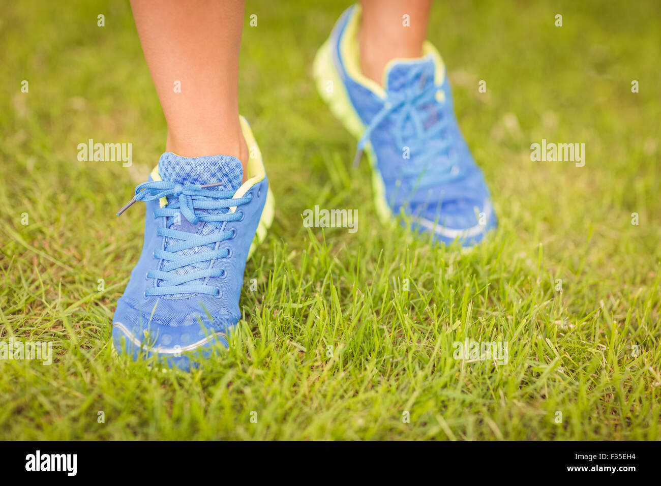 Low section of person walking on grass Stock Photo - Alamy