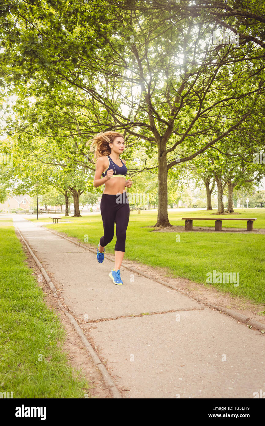 Woman running in park Stock Photo - Alamy