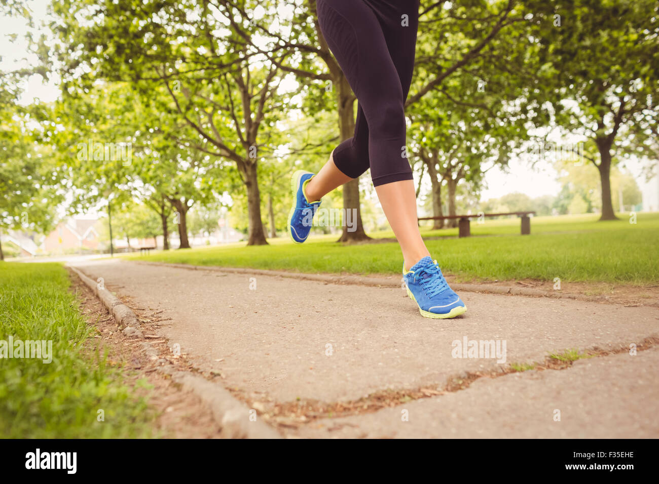 Woman running at park Stock Photo - Alamy
