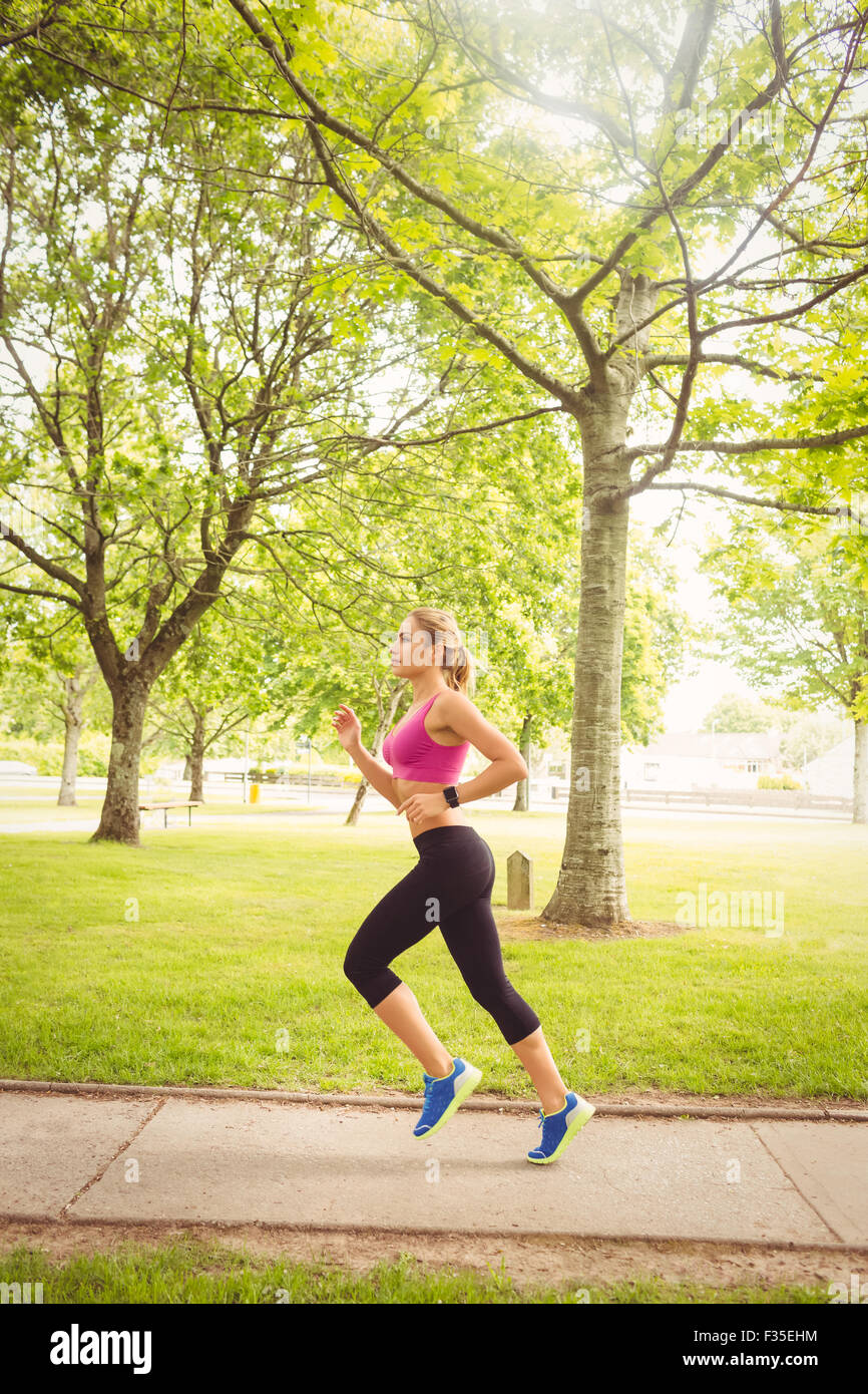 Side view of woman jogging in park Stock Photo - Alamy