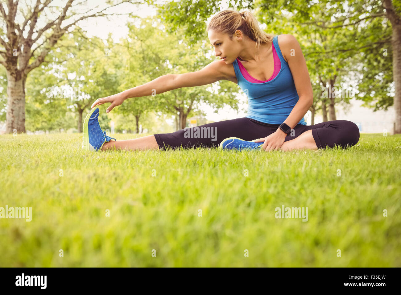 Full length of sporty woman stretching leg Stock Photo - Alamy