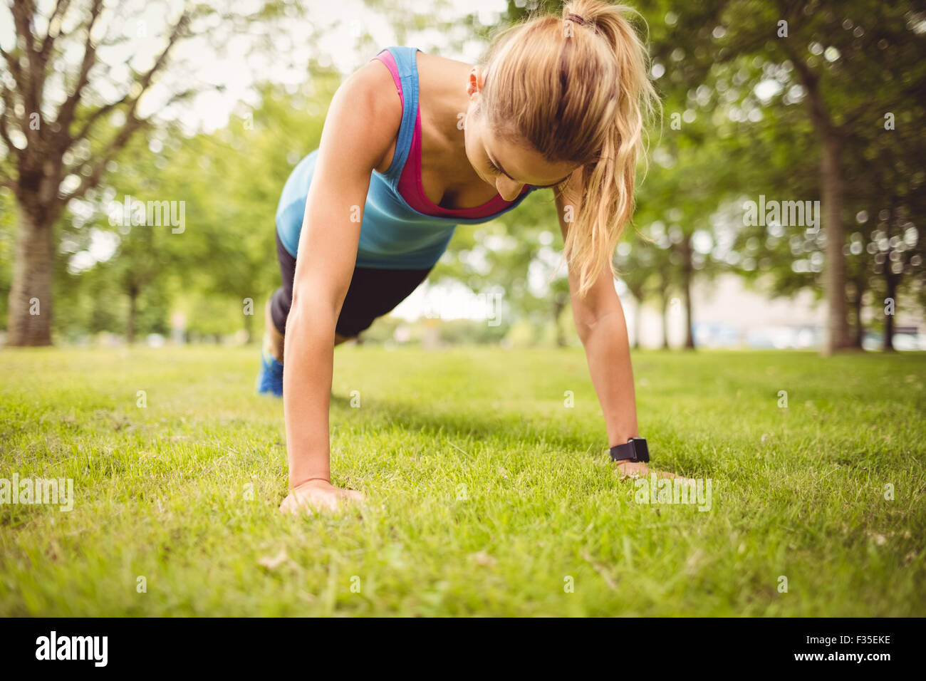 Woman doing exercise in park Stock Photo - Alamy