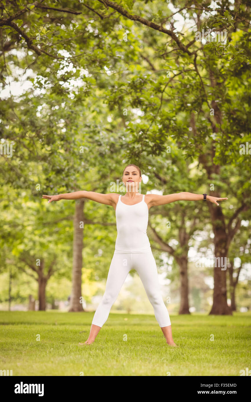 Full length of confident woman exercising with arms outstretched Stock ...