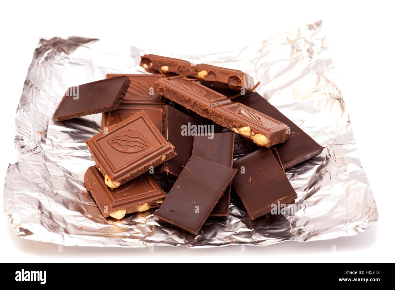 Broken Chocolate bar in foil isolated on white background Stock Photo ...