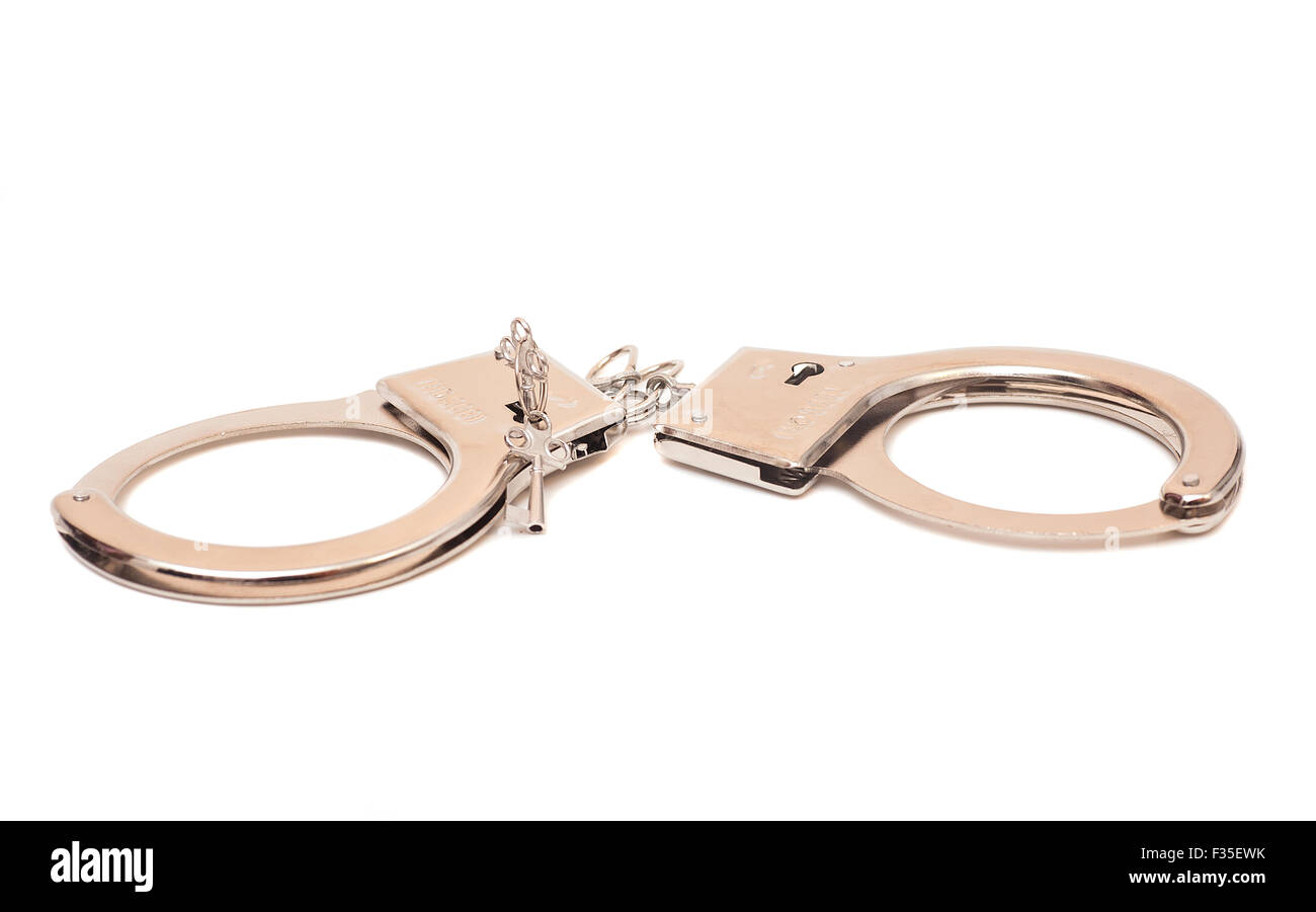 Handcuffs isolated in white background Stock Photo - Alamy