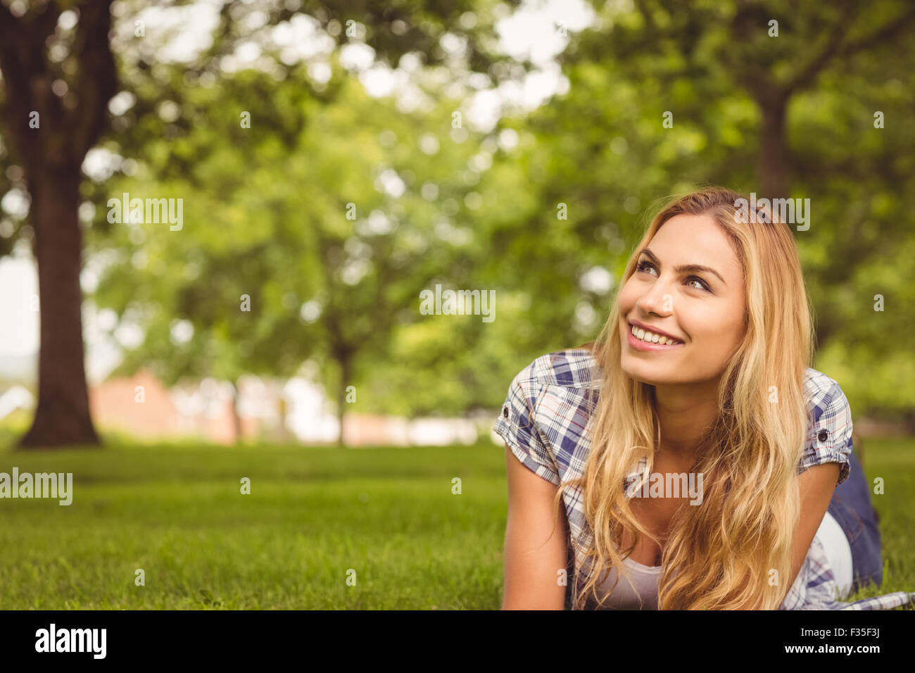 Happy woman relaxing at park Stock Photo - Alamy