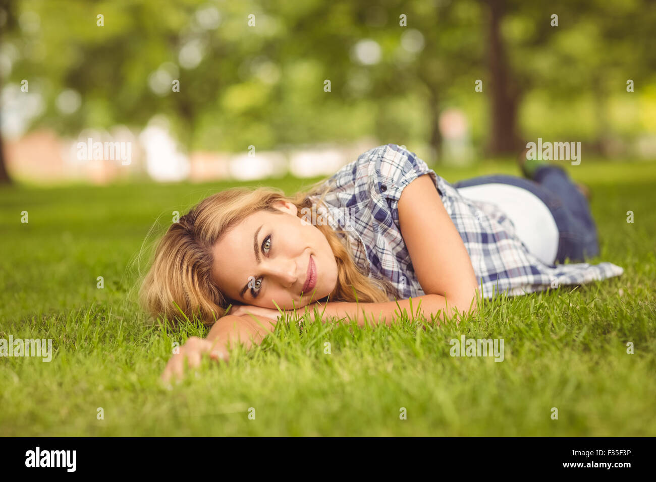 Portrait of cheerful woman lying on front Stock Photo - Alamy