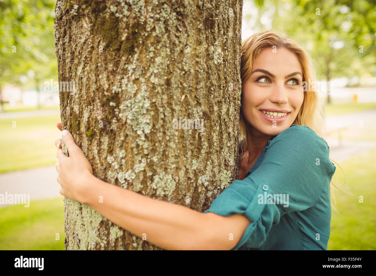 Woman hugging tree hi-res stock photography and images - Alamy