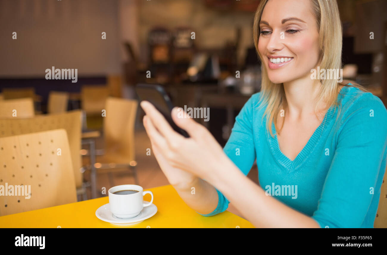Young woman on table and using phone hi-res stock photography and ...
