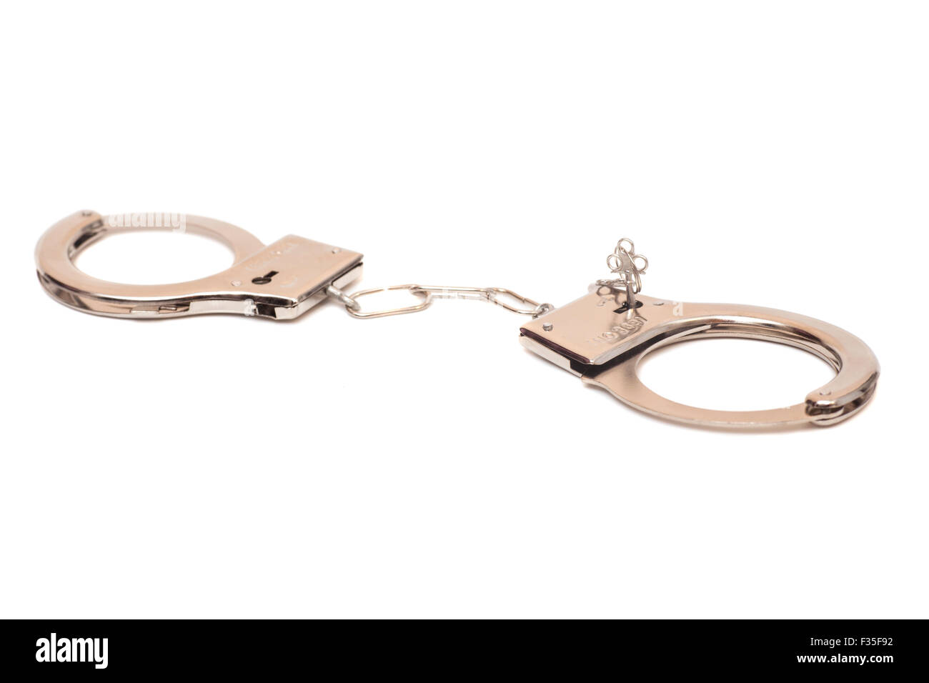 Handcuffs isolated on white background Stock Photo - Alamy
