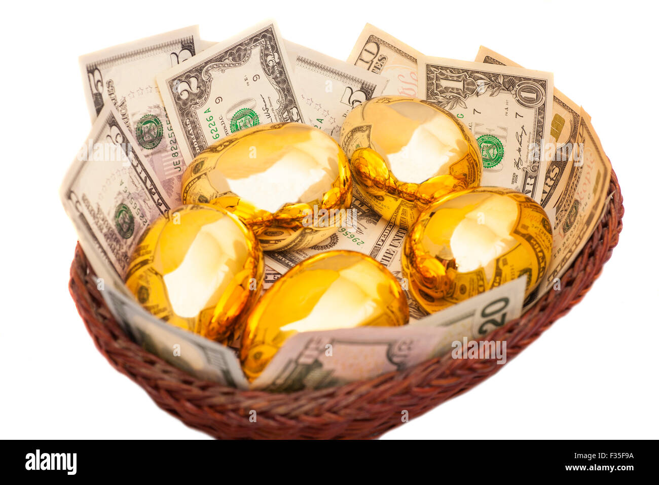 Golden eggs and dollars in basket isolated on white background Stock ...