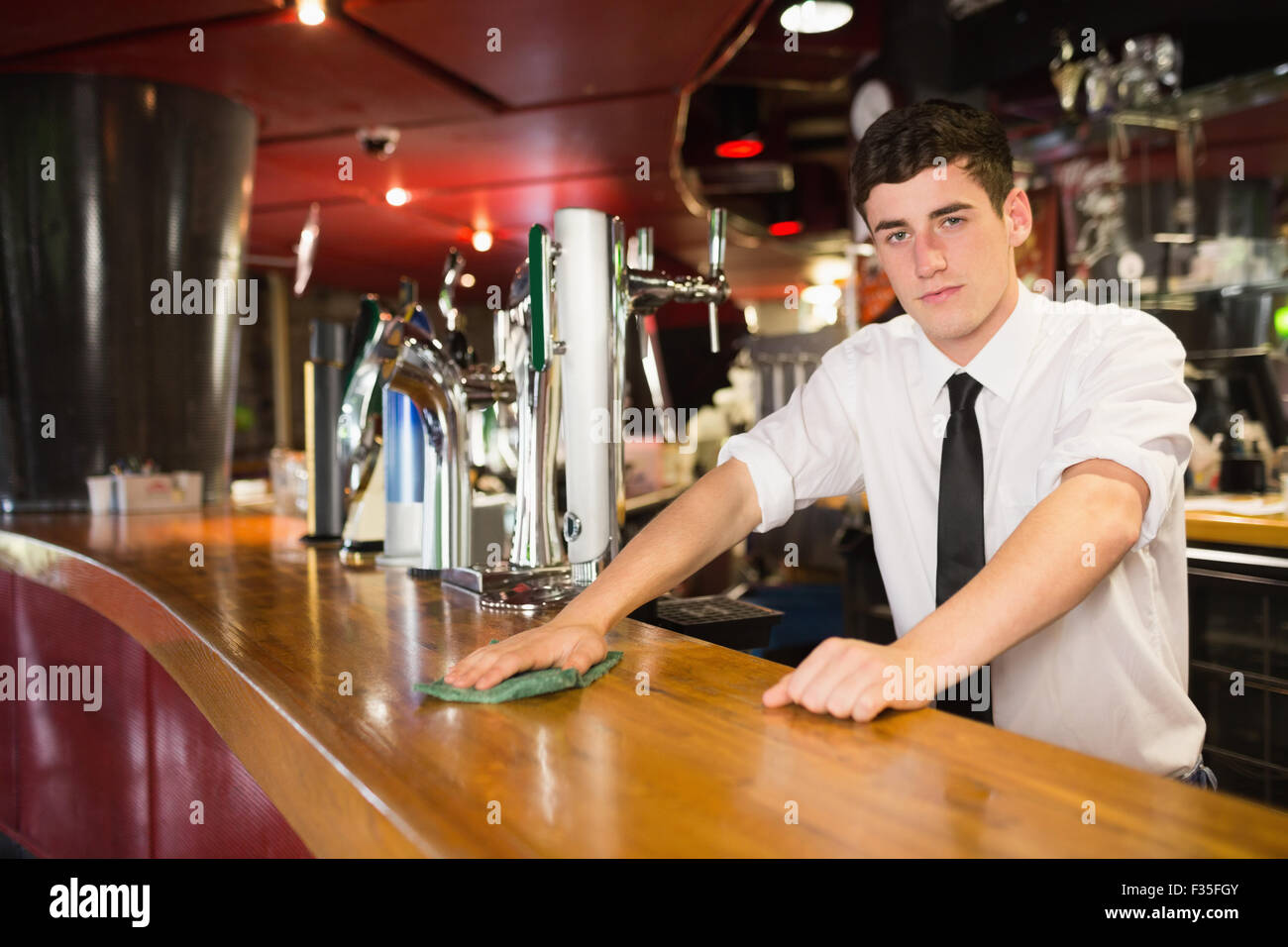 Confident male bartender cleaning bar hi-res stock photography and ...