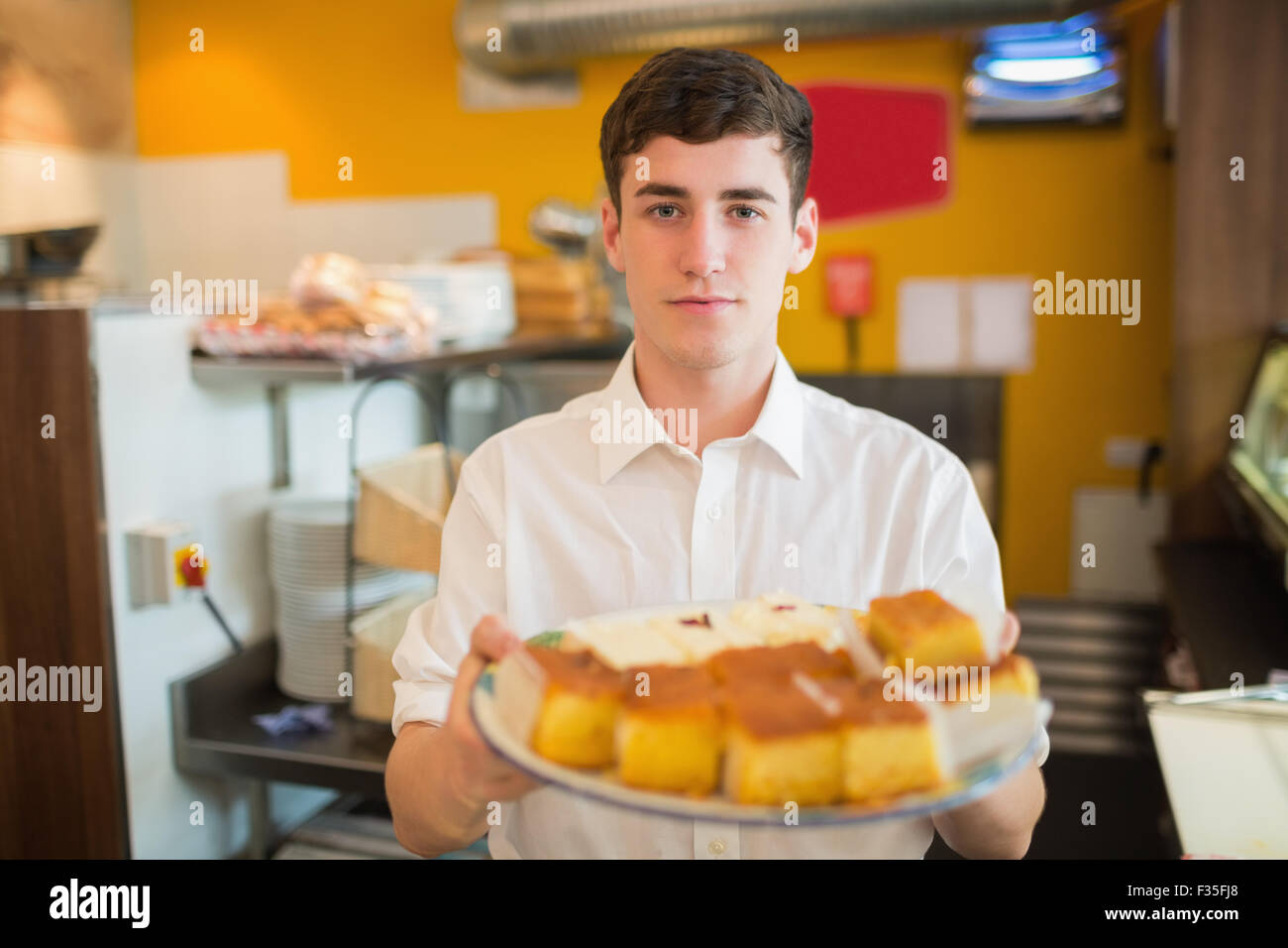 Male worker with pastries in bakery Stock Photo - Alamy