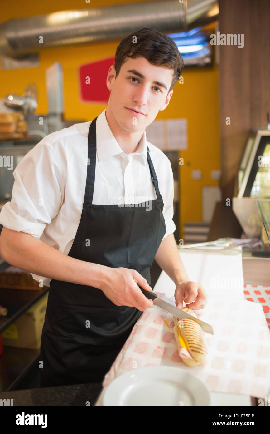 Portrait of male worker cutting sandwich Stock Photo - Alamy