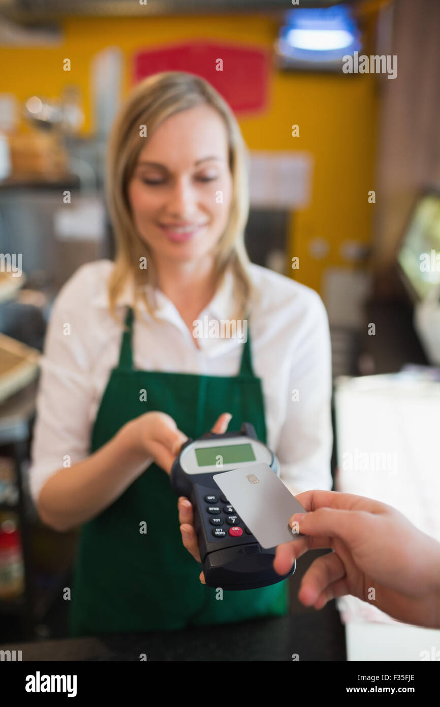 Female worker accepting payment through credit card Stock Photo - Alamy