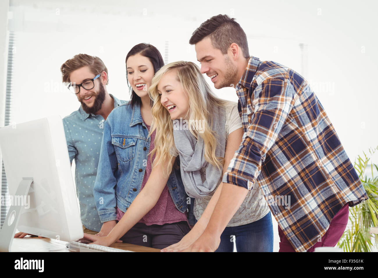 Happy business people working at computer desk Stock Photo - Alamy