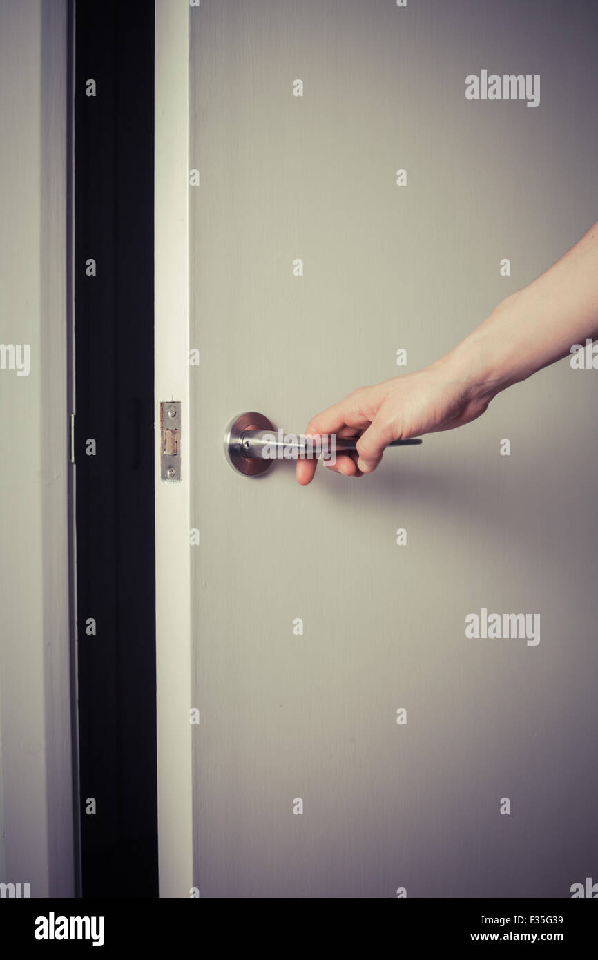 Woman hand on door handle hi-res stock photography and images - Alamy