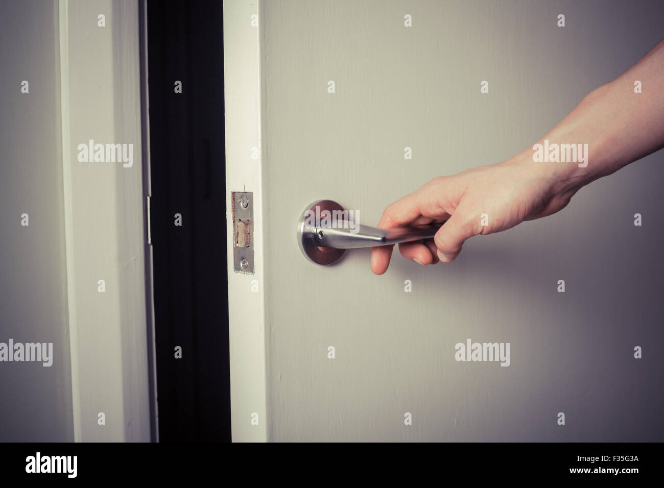 Woman hand on door handle hi-res stock photography and images - Alamy