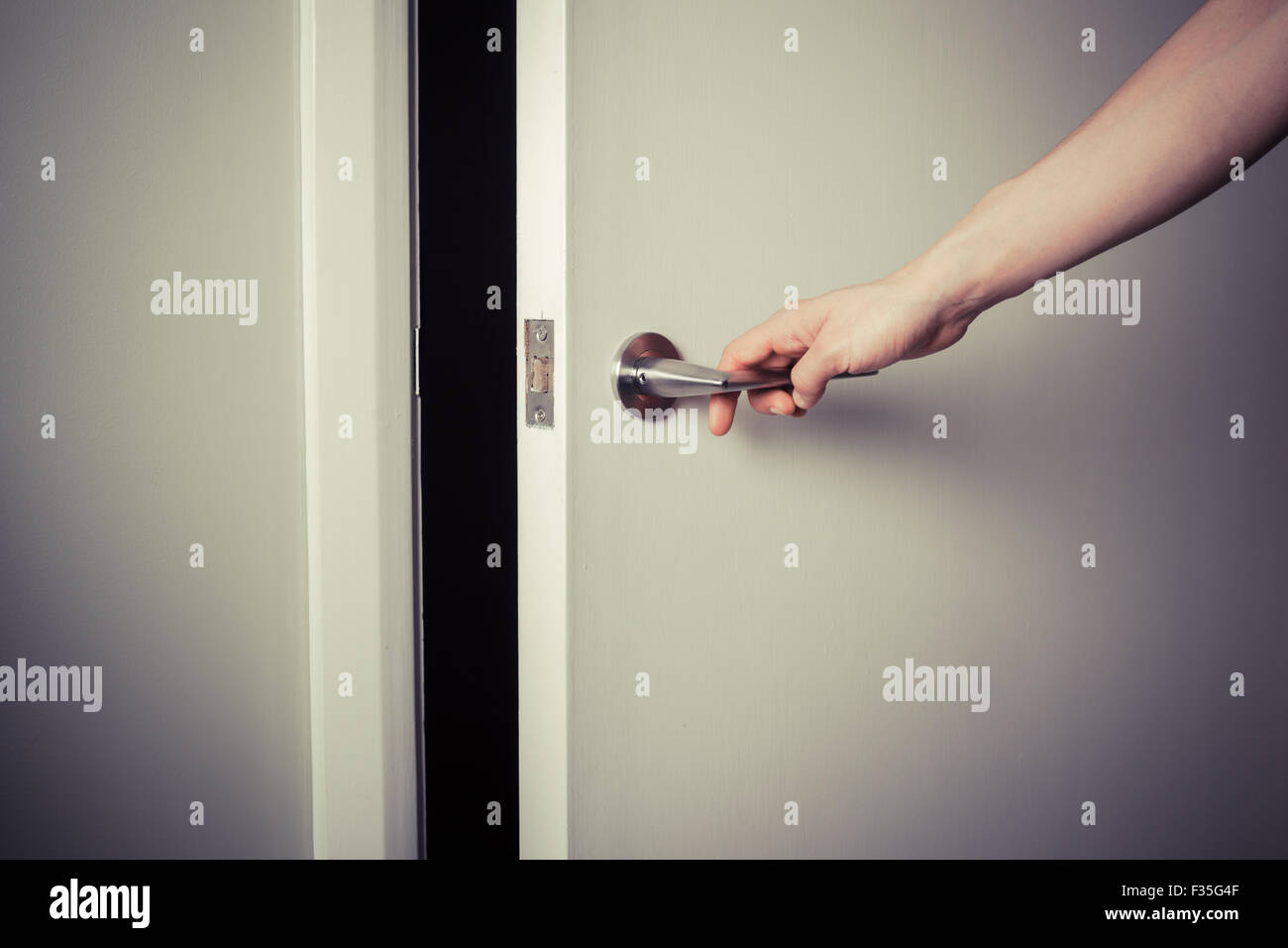 Woman hand on door handle hi-res stock photography and images - Alamy