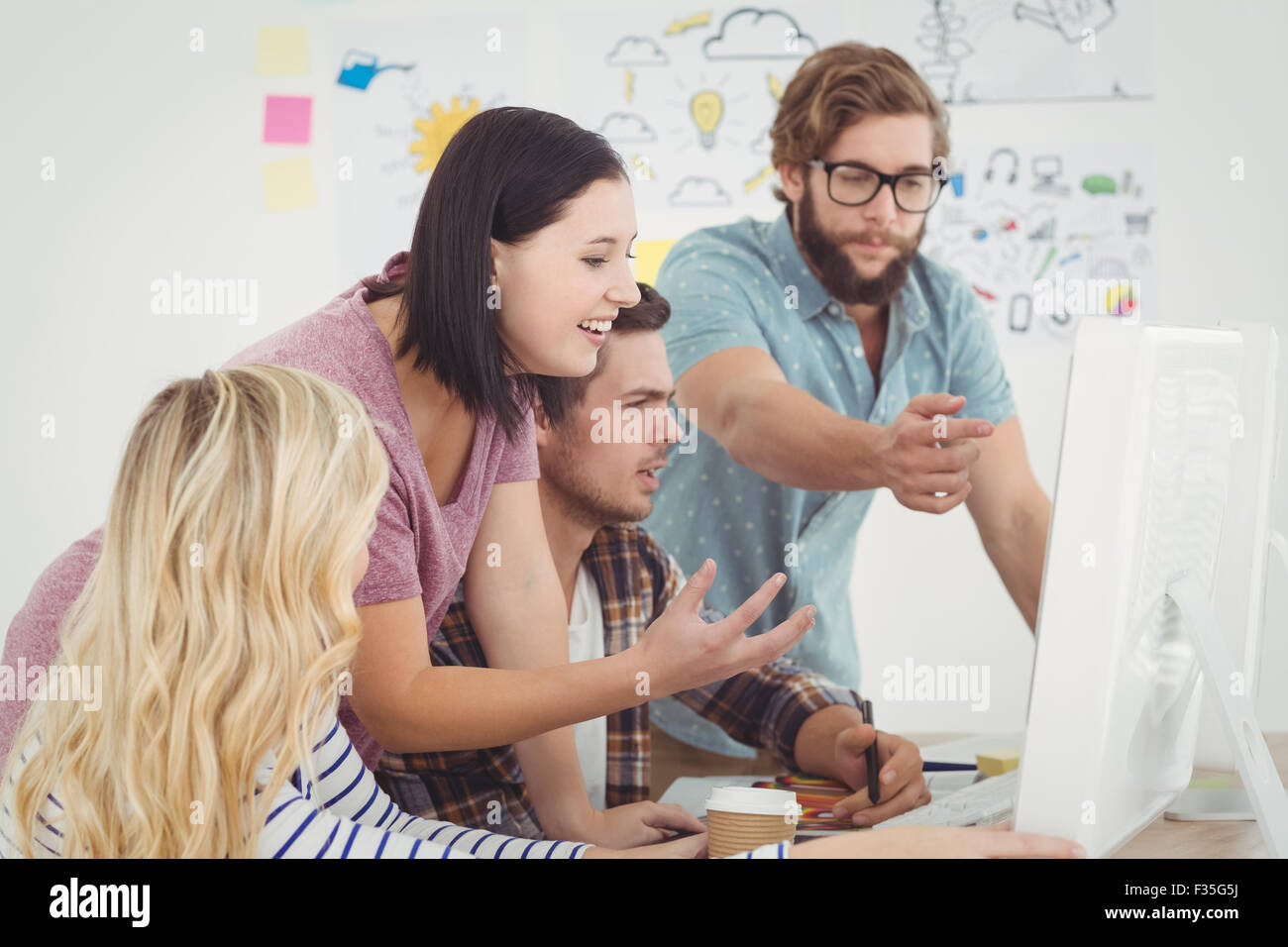 Group young people looking at computer hi-res stock photography and ...