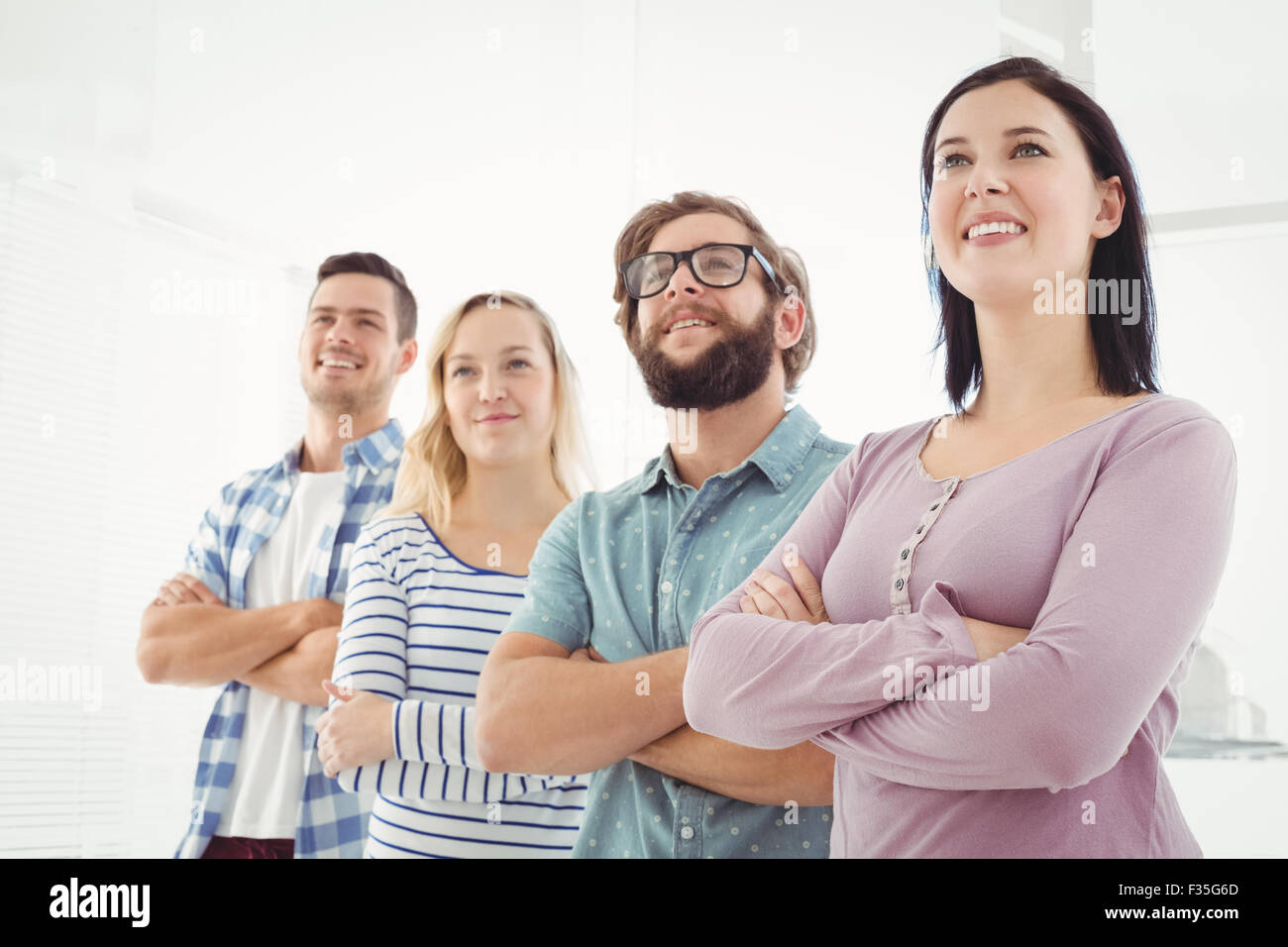 Smiling business people standing in row with arms crossed Stock Photo ...
