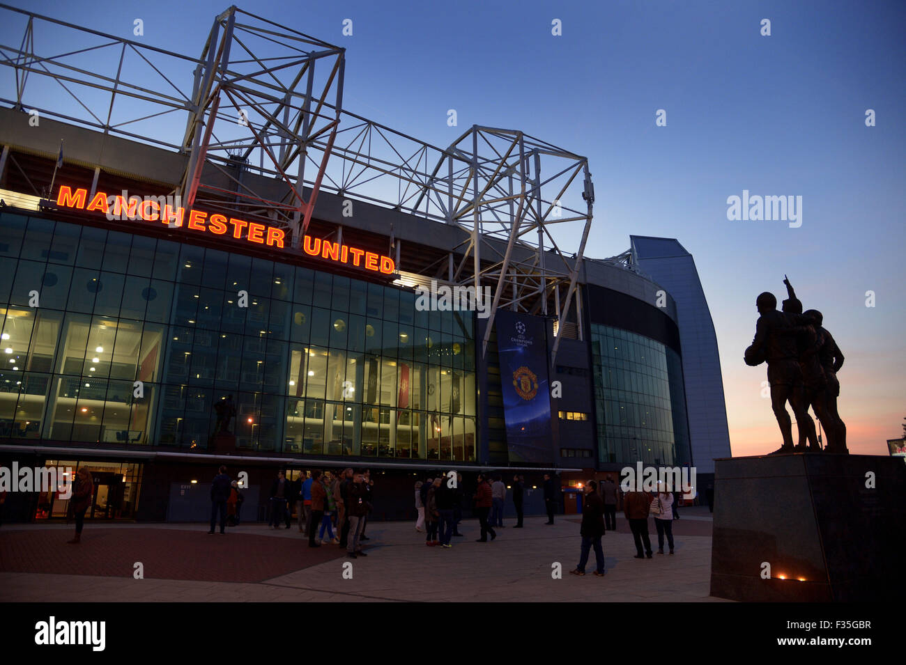 The Old Trafford in Manchester with the United Trinity Sculpture (L ...
