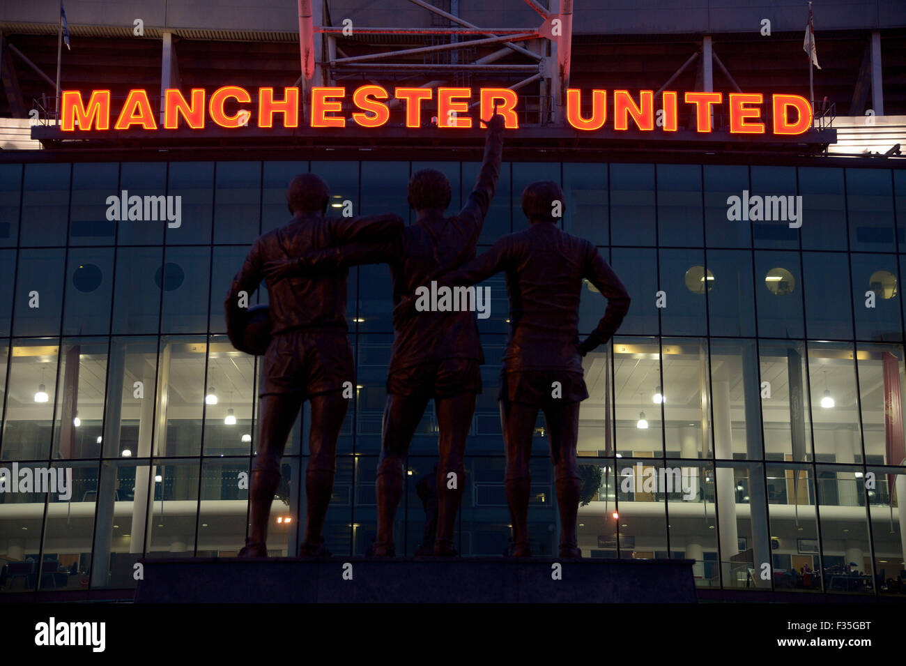 The Old Trafford in Manchester with the United Trinity Sculpture (front ...