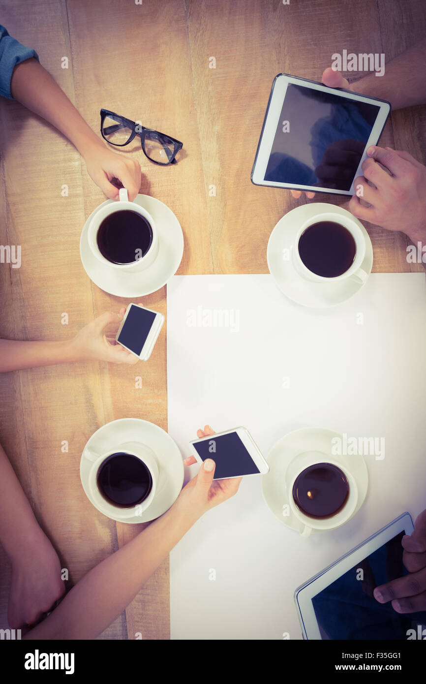 Overhead view of people using technology at desk Stock Photo - Alamy
