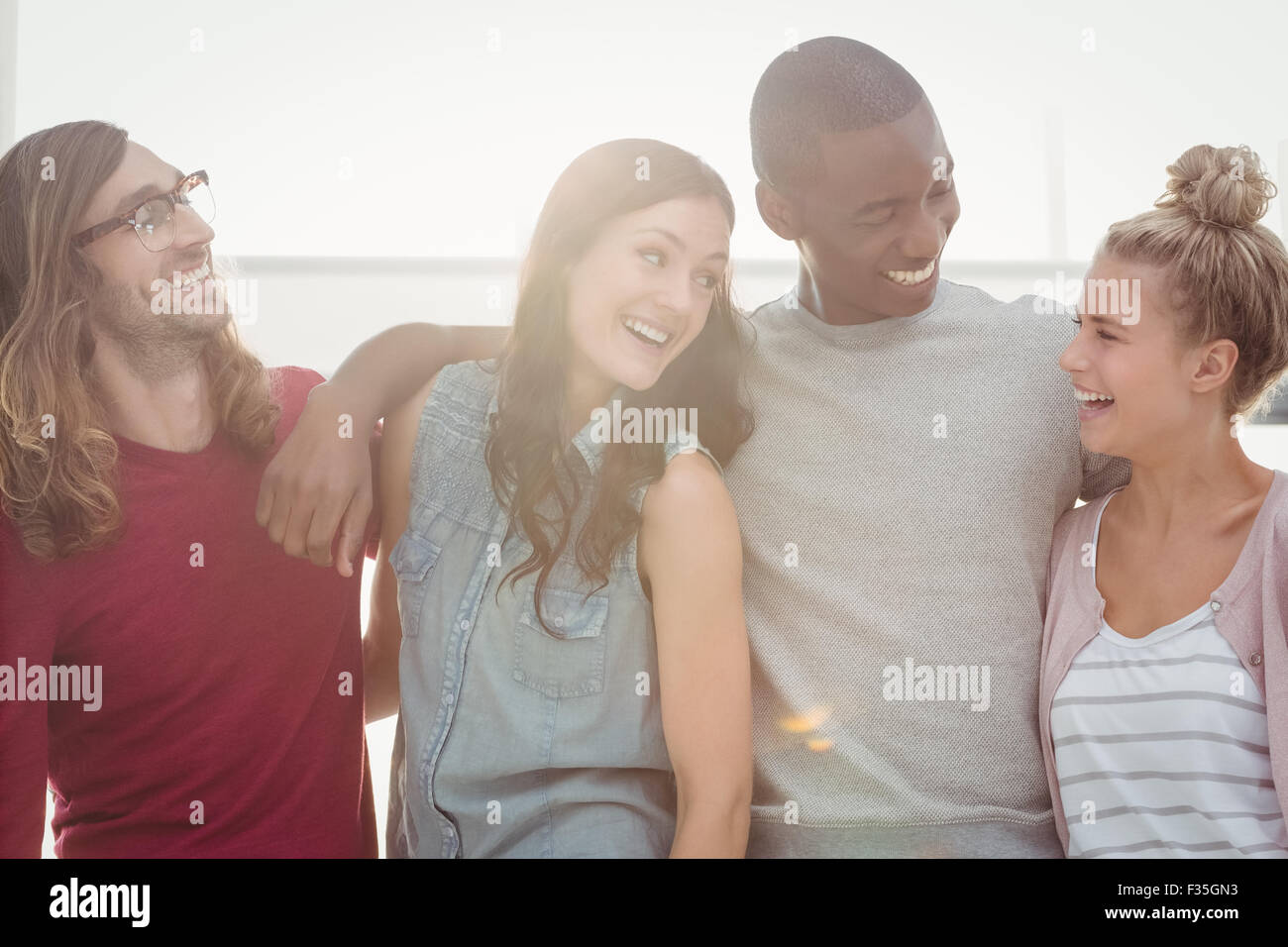 Smiling people with arms around Stock Photo - Alamy