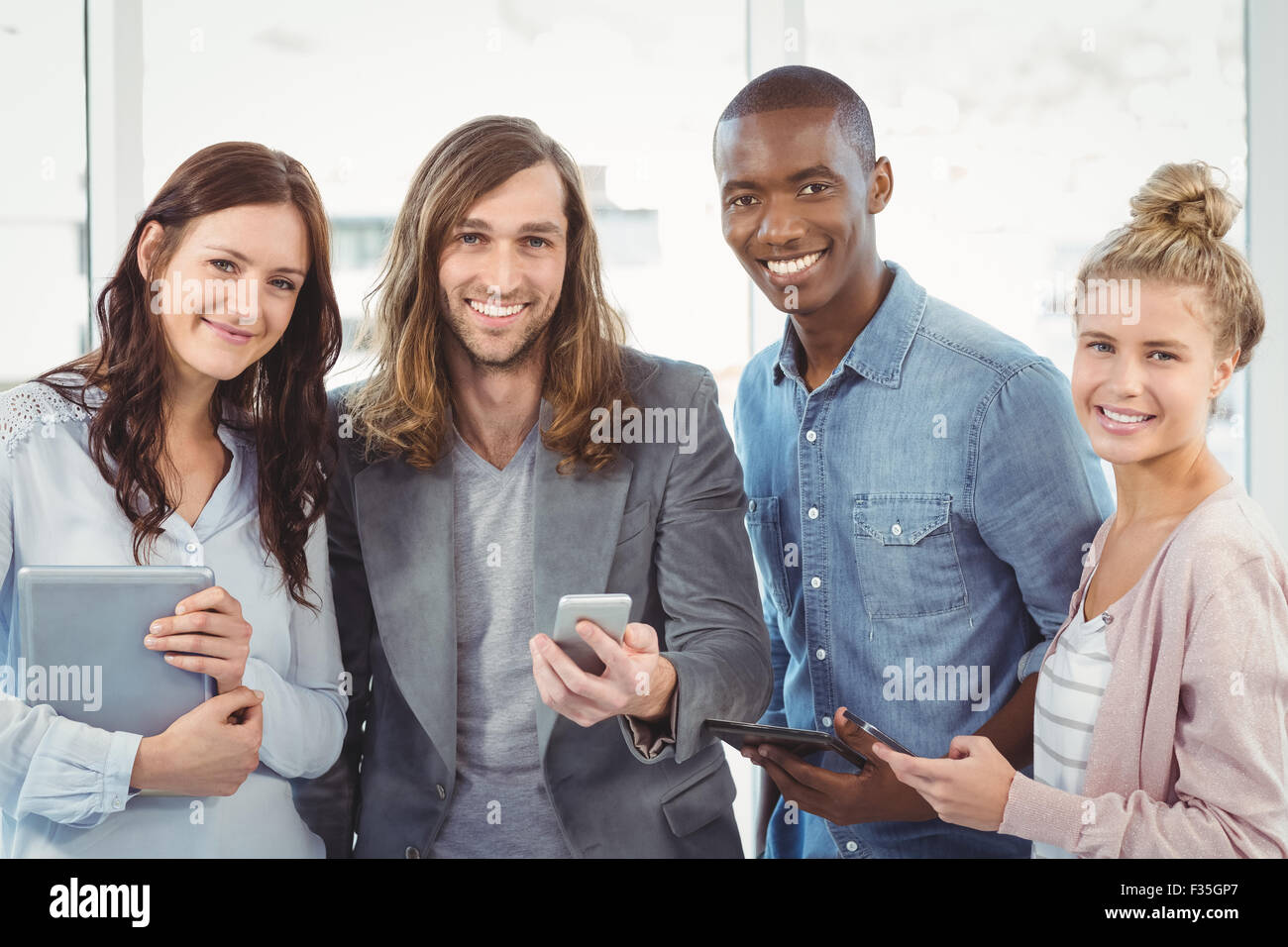Portrait of smiling business team using technology Stock Photo - Alamy