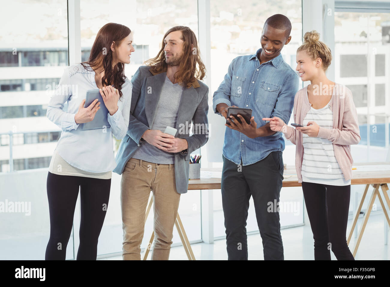 Business team using technology at creative office Stock Photo - Alamy