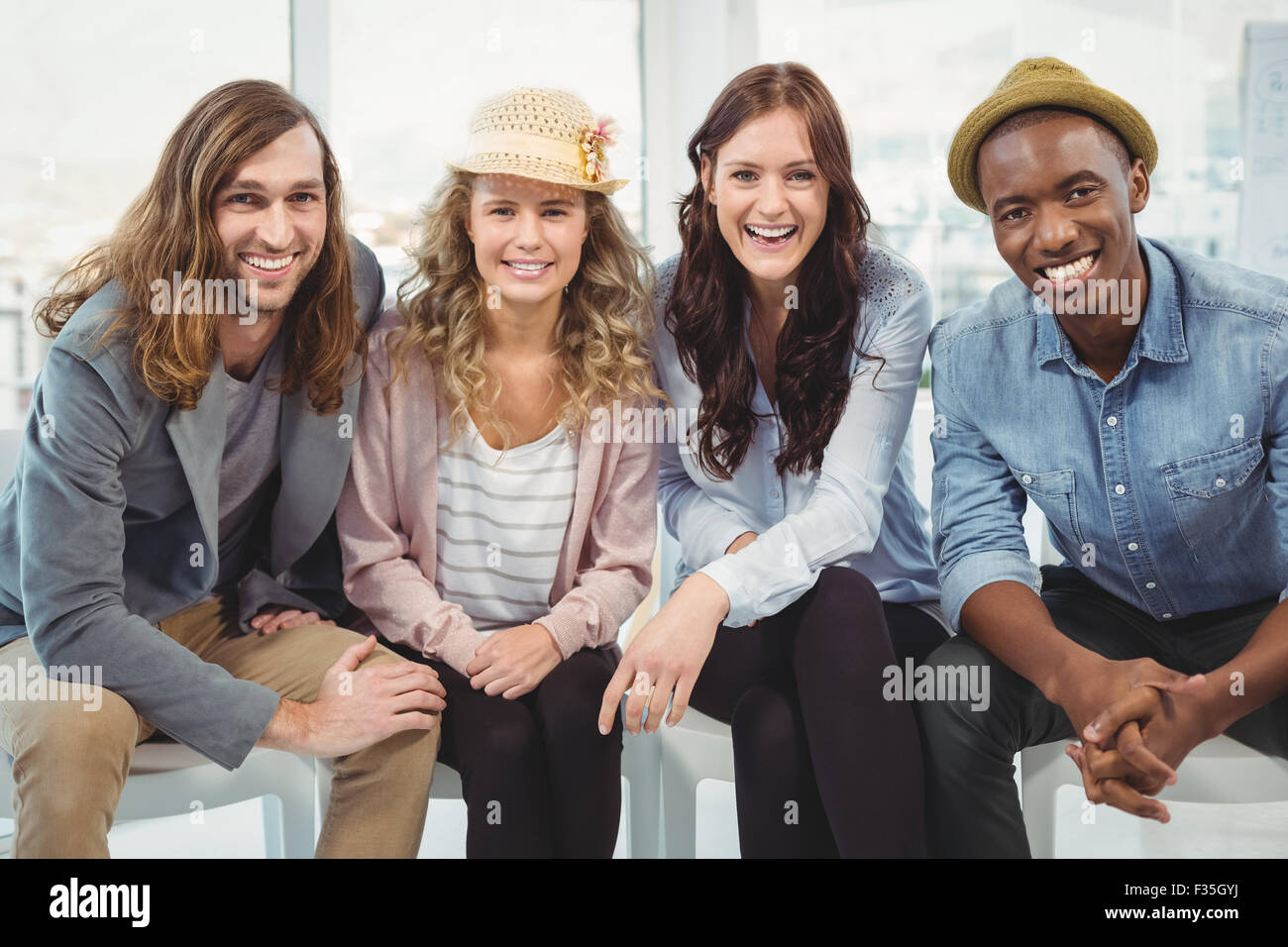 Portrait of smiling business people sitting on chair Stock Photo - Alamy