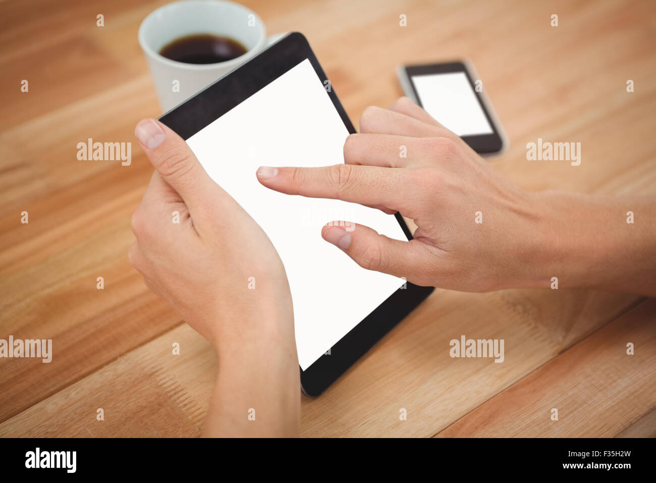 Man using digital tablet at desk in office Stock Photo - Alamy