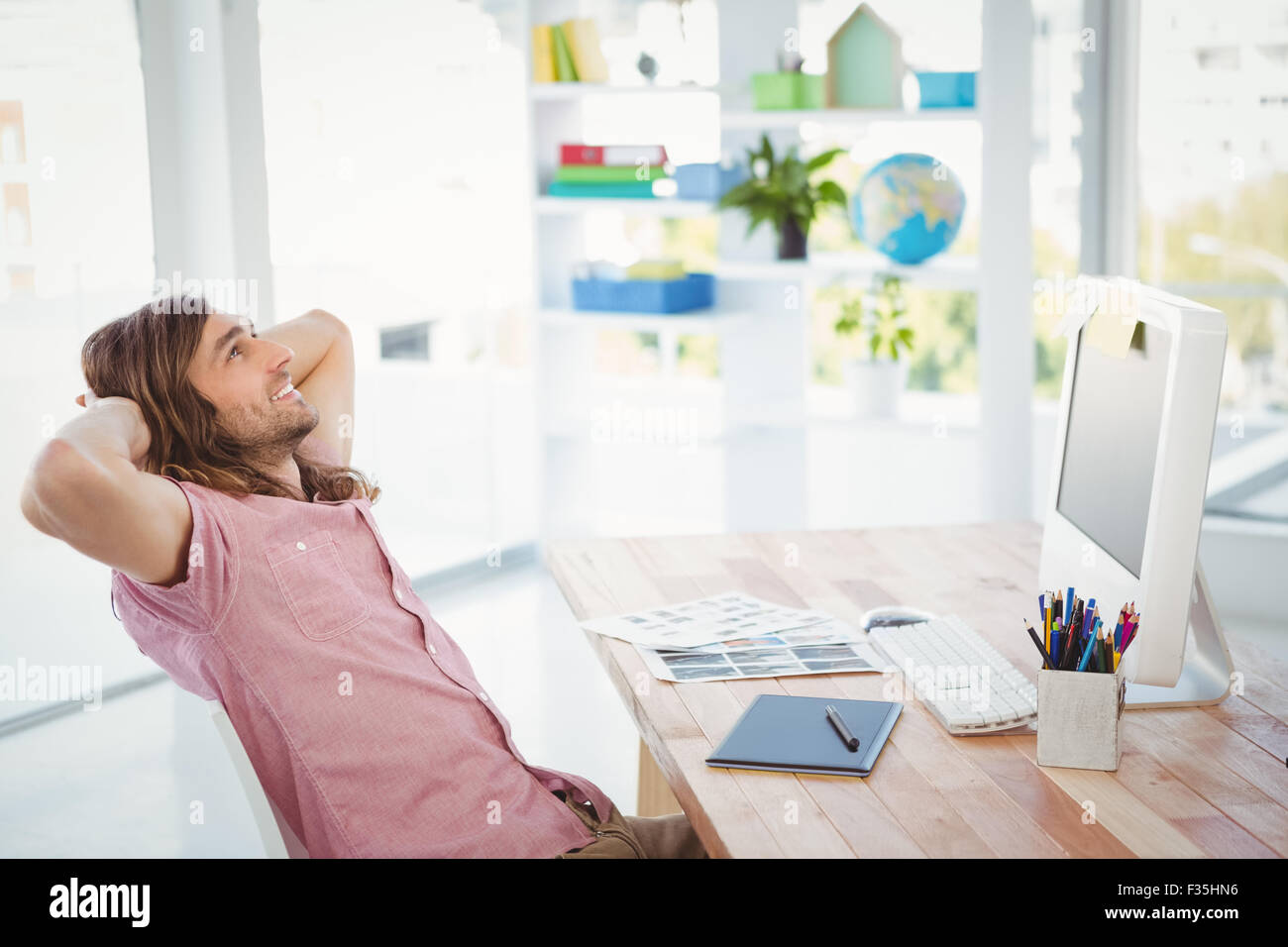 Side view of hipster relaxing at computer desk Stock Photo - Alamy
