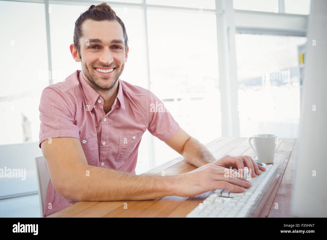 Portrait of happy businessman working on computer Stock Photo - Alamy