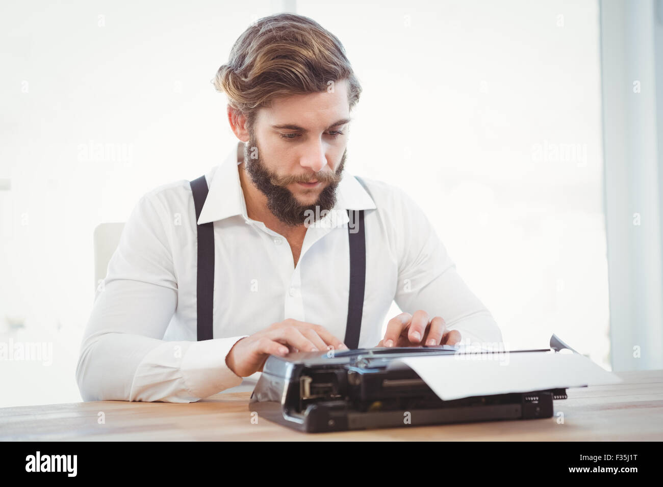 Hipster working on typewriter Stock Photo - Alamy