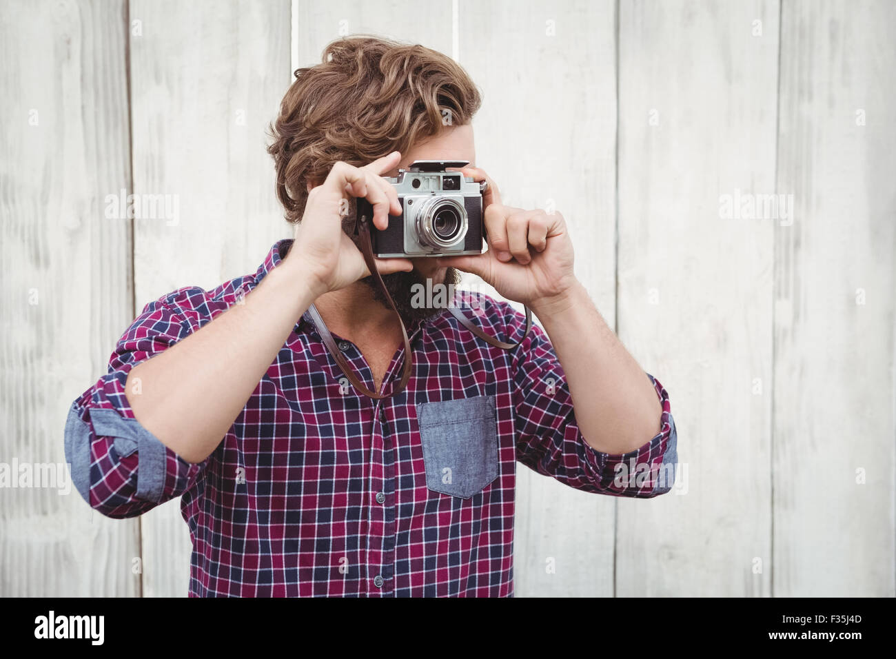 Hipster photographing with camera Stock Photo - Alamy