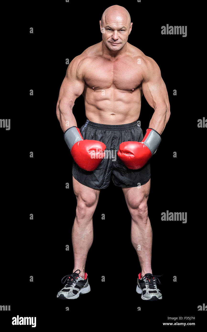 Portrait full length of bald boxer flexing muscles Stock Photo - Alamy