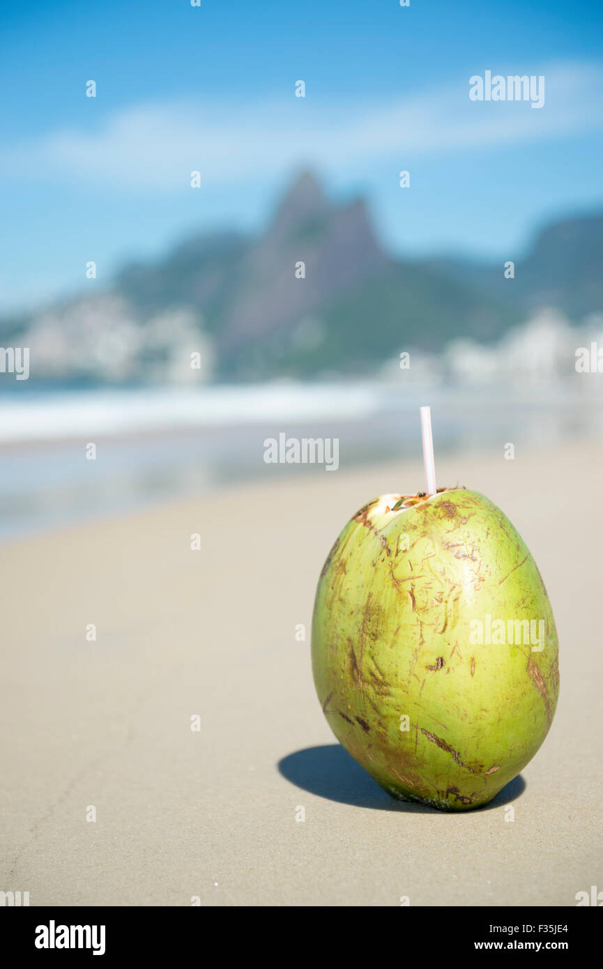 Green coconut coco gelado on Ipanema Beach against a backdrop of Two ...